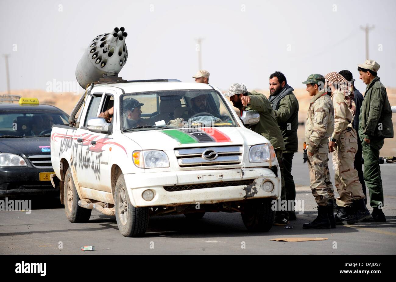 Libyan rebels position a rocket launcher in Ajdabiya, Libya, 6 April ...