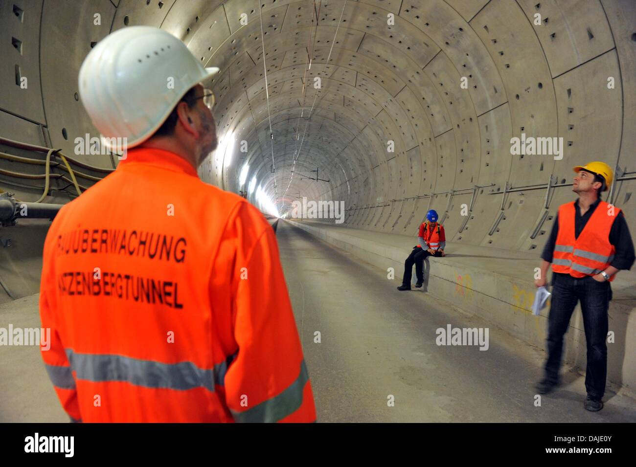 Participants of a press tour through the Katzenberg Tunnel look at the ...