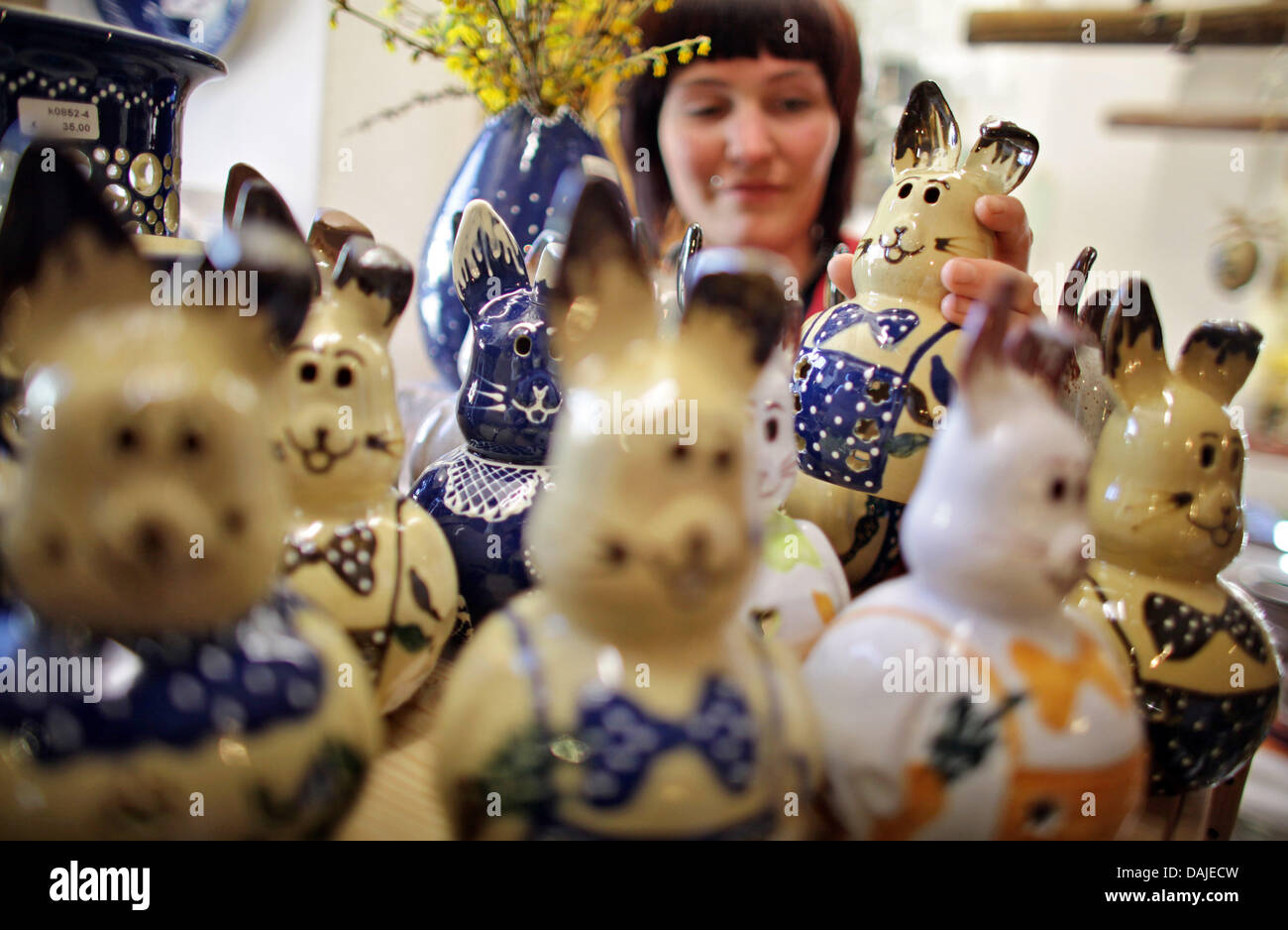 Member of staff of one of Germany's oldest pottery workshops, Janine Friebig, organises a shelf ...