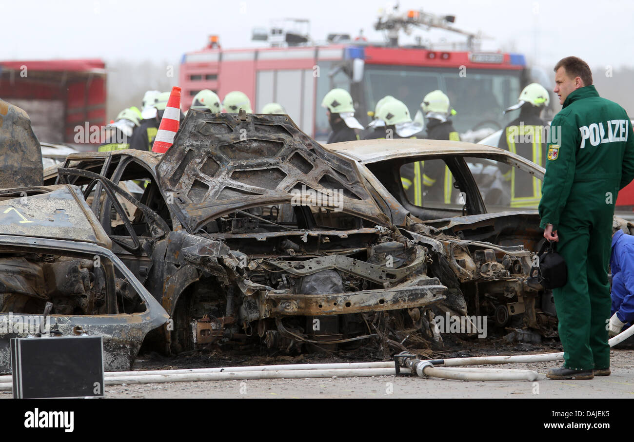 Investigators from the fire and police department are on the scene at a ...