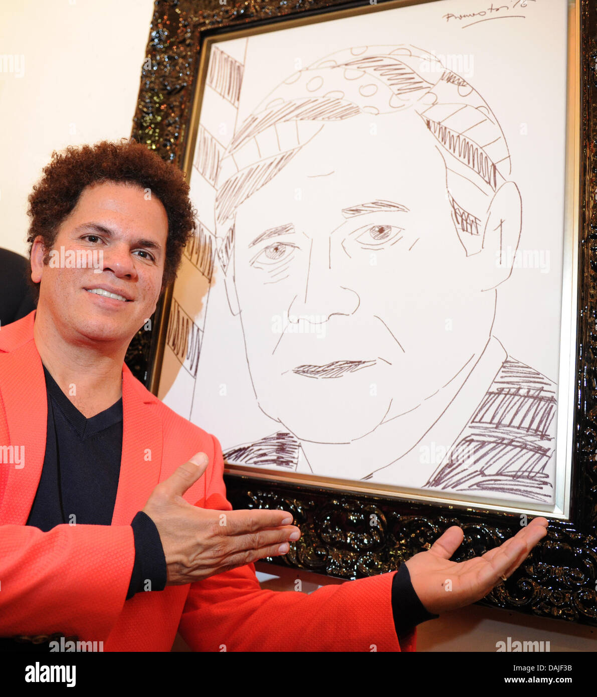 Pop art painter Romero Britto presents a portrait of former German ...