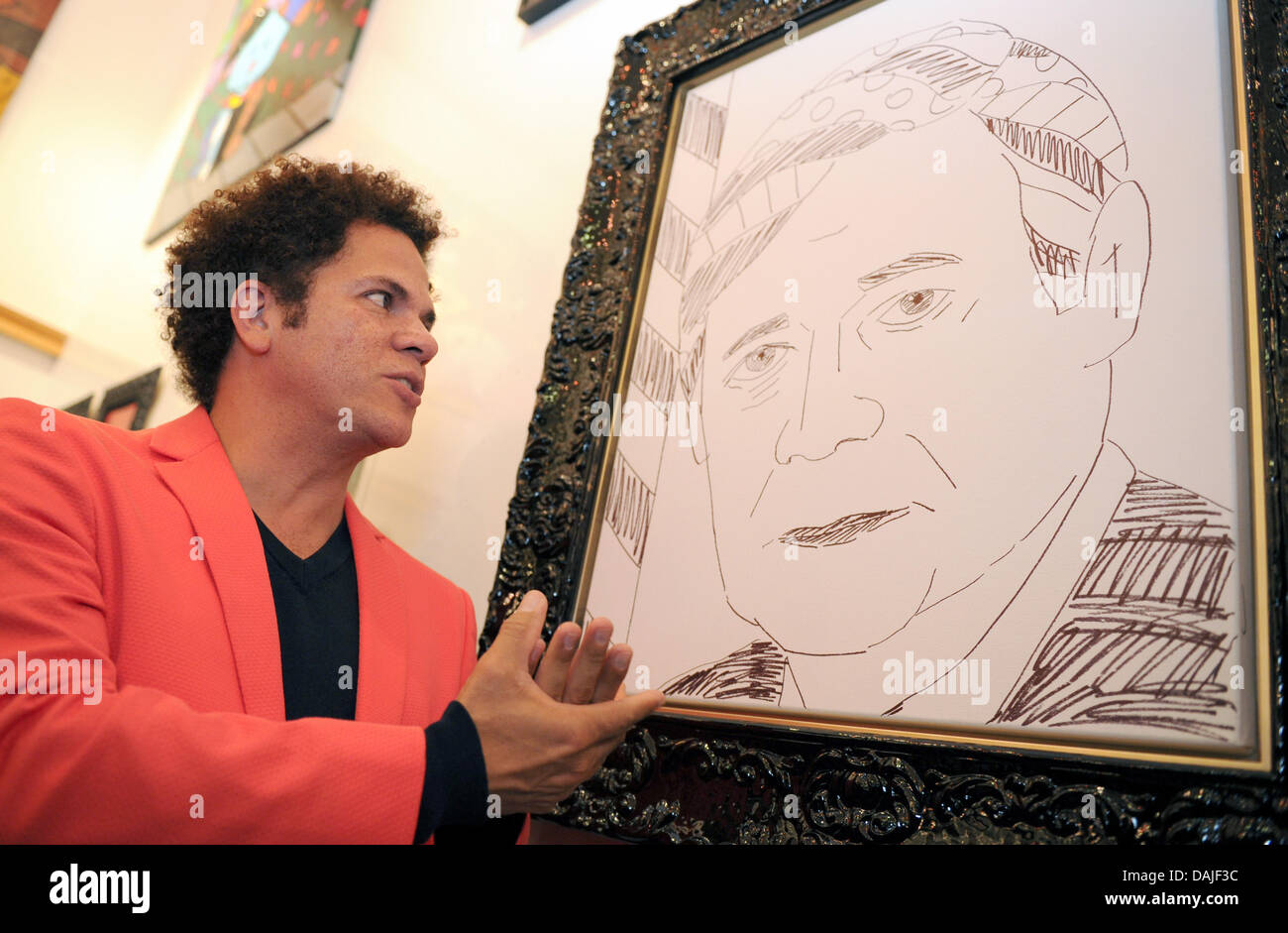 Pop art painter Romero Britto presents a portrait of former German ...