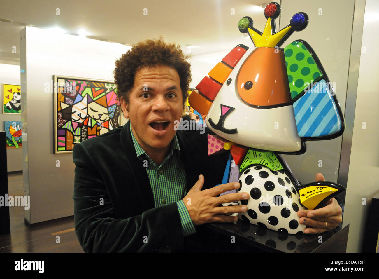 Brazilian Pop art painter and sculptor Romero Britto poses next to one ...