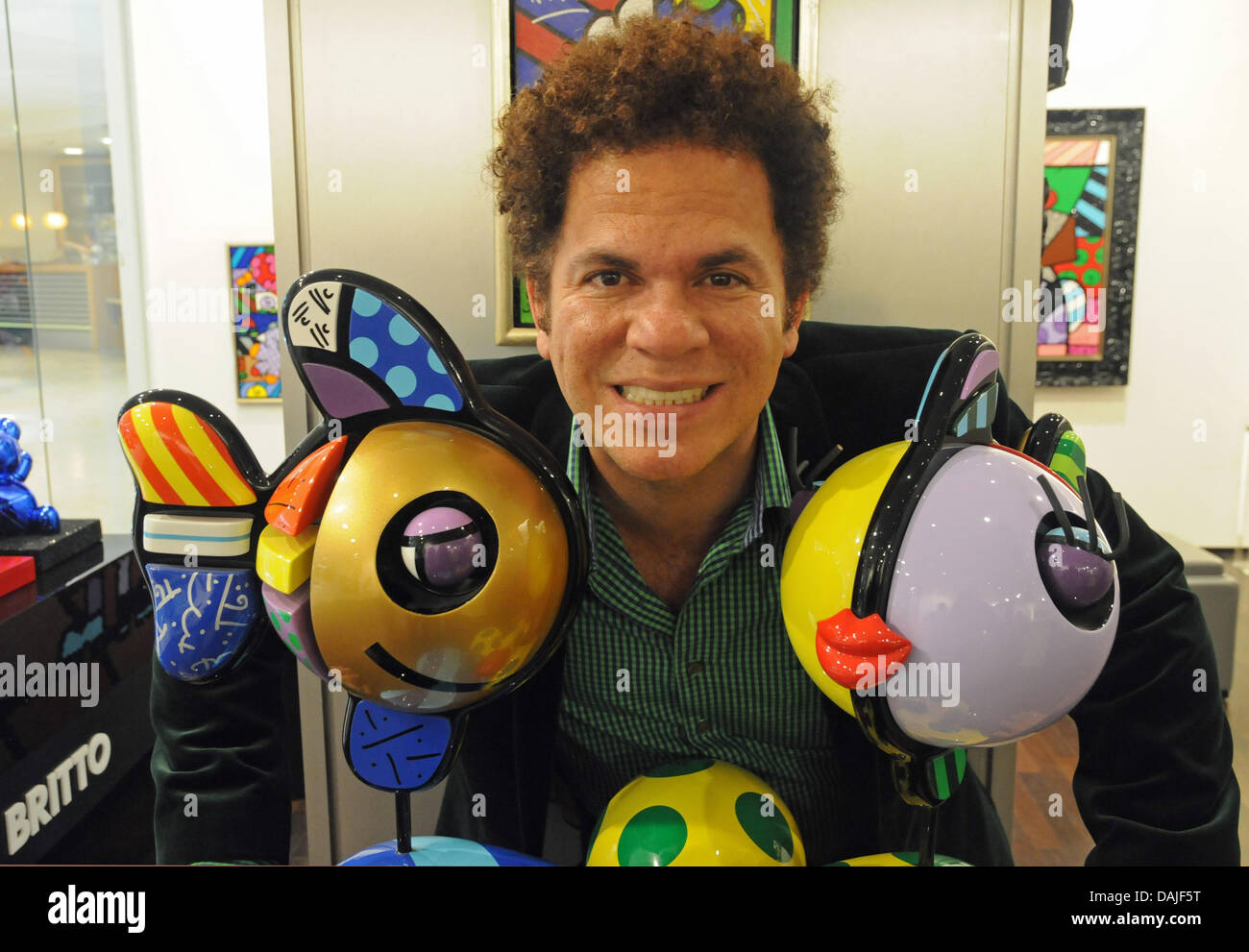 Brazilian Pop art painter and sculptor Romero Britto poses next to one ...