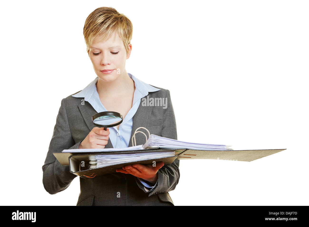 Business woman with big magnifying glass reading fineprint of a ...