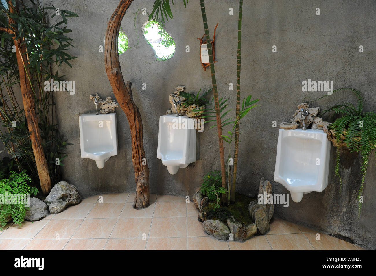 Richly decorated urinals with plants are on display in the bathroom of ...