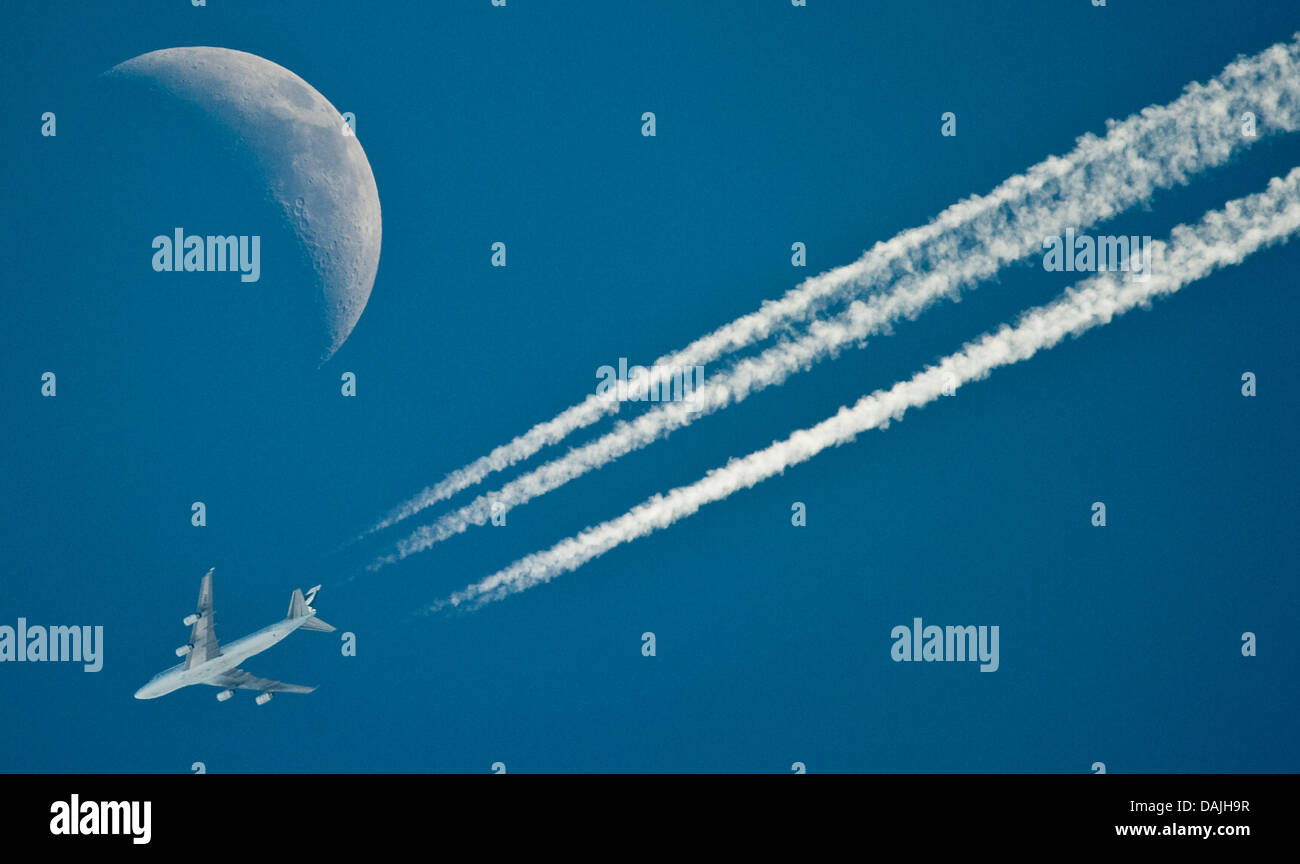 A four-jet-engine plane seemingly passes the moon, flying over ...
