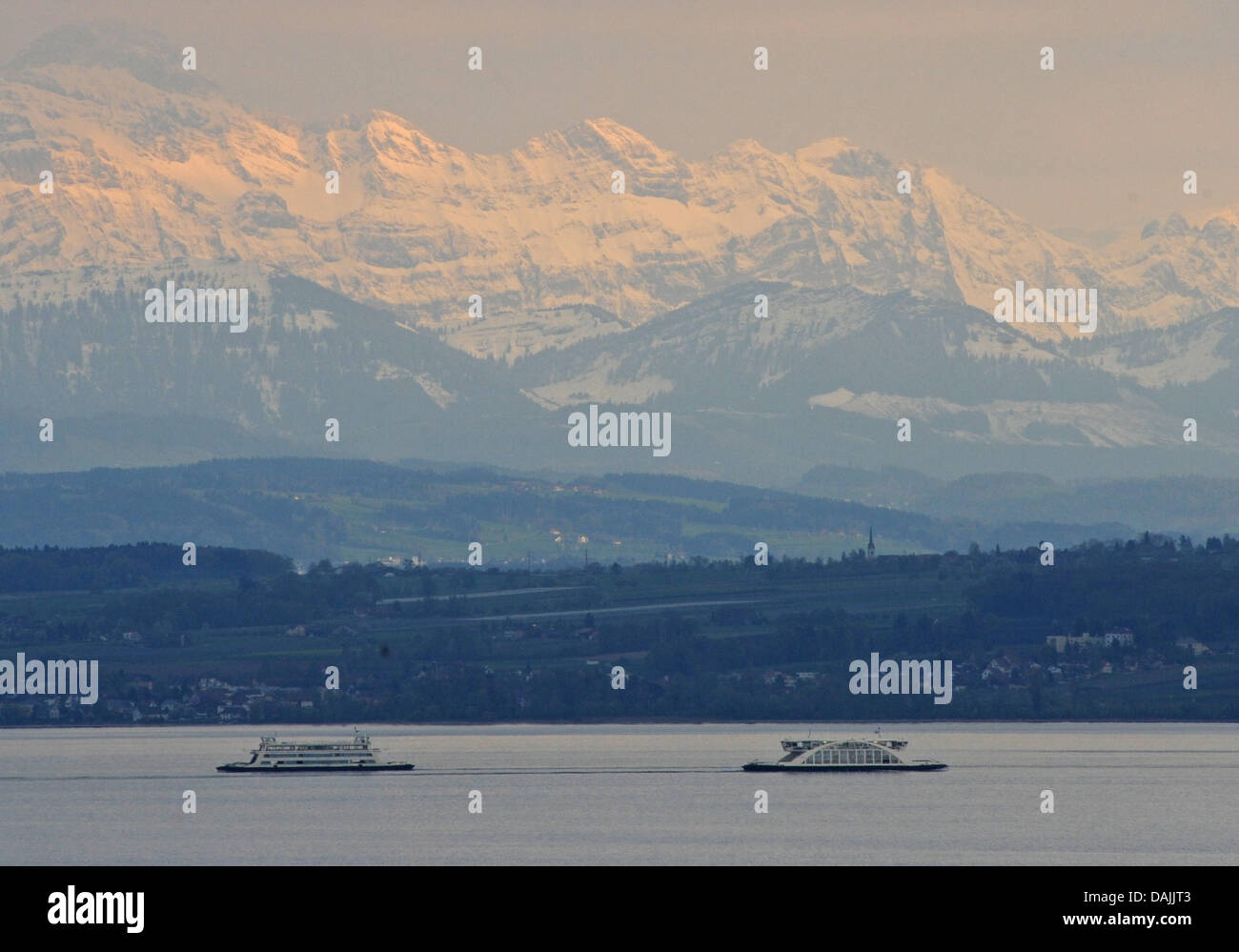 Two ferries sail in front of the Alps across Lake Constance, Germany ...