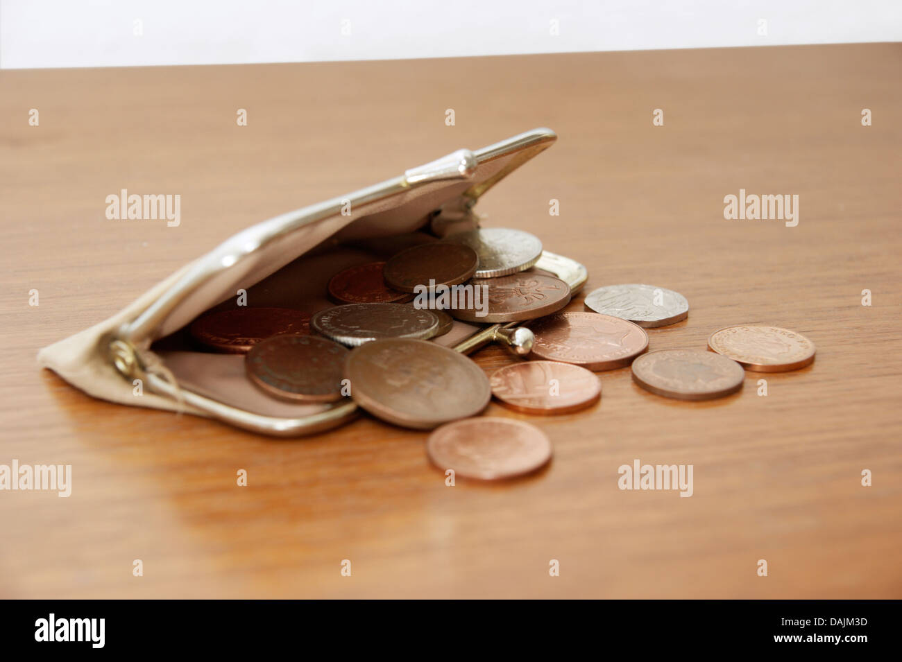 Purse filled with uk coins hi-res stock photography and images - Alamy