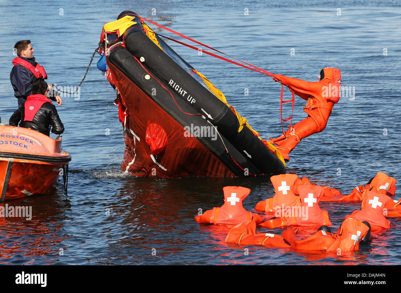 A group of crew members of cruiseliners train the turning and setting ...