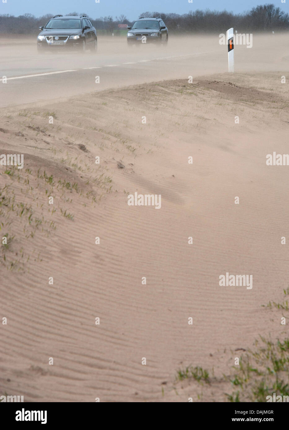 A sandstorm blows over the windy country lane B105 near the junction at ...