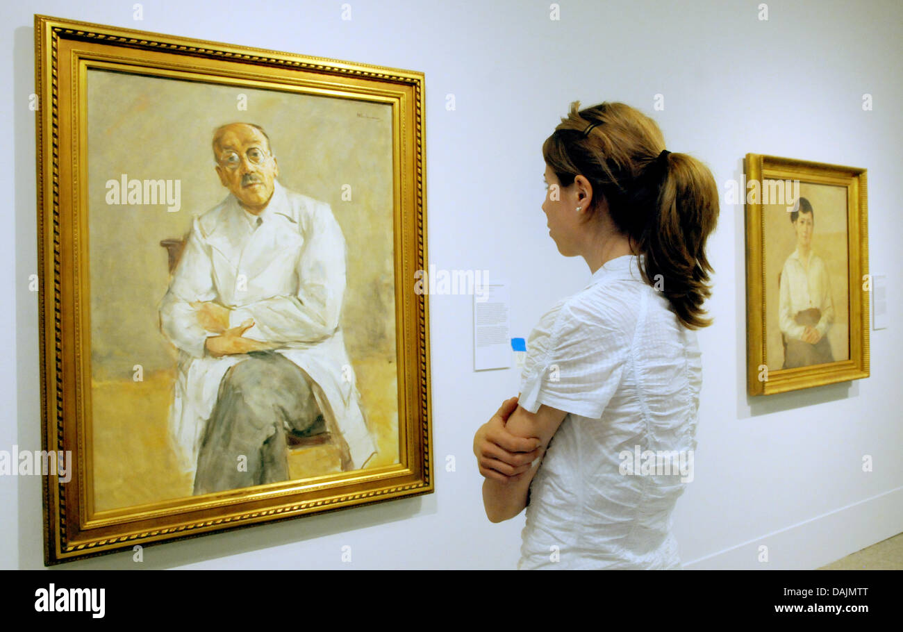 A woman views the pictures 'The surgeon Ferdinand Sauerbruch' (L) and ...