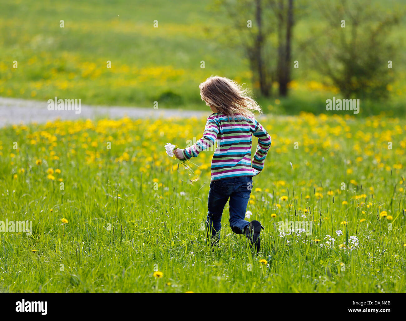 Germany, Baden Wuerttemberg, Girl running in meadow Stock Photo - Alamy