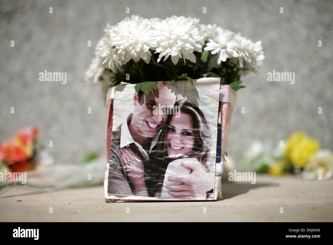 Flowers with a picture of the crown princely couple at a memorial are ...