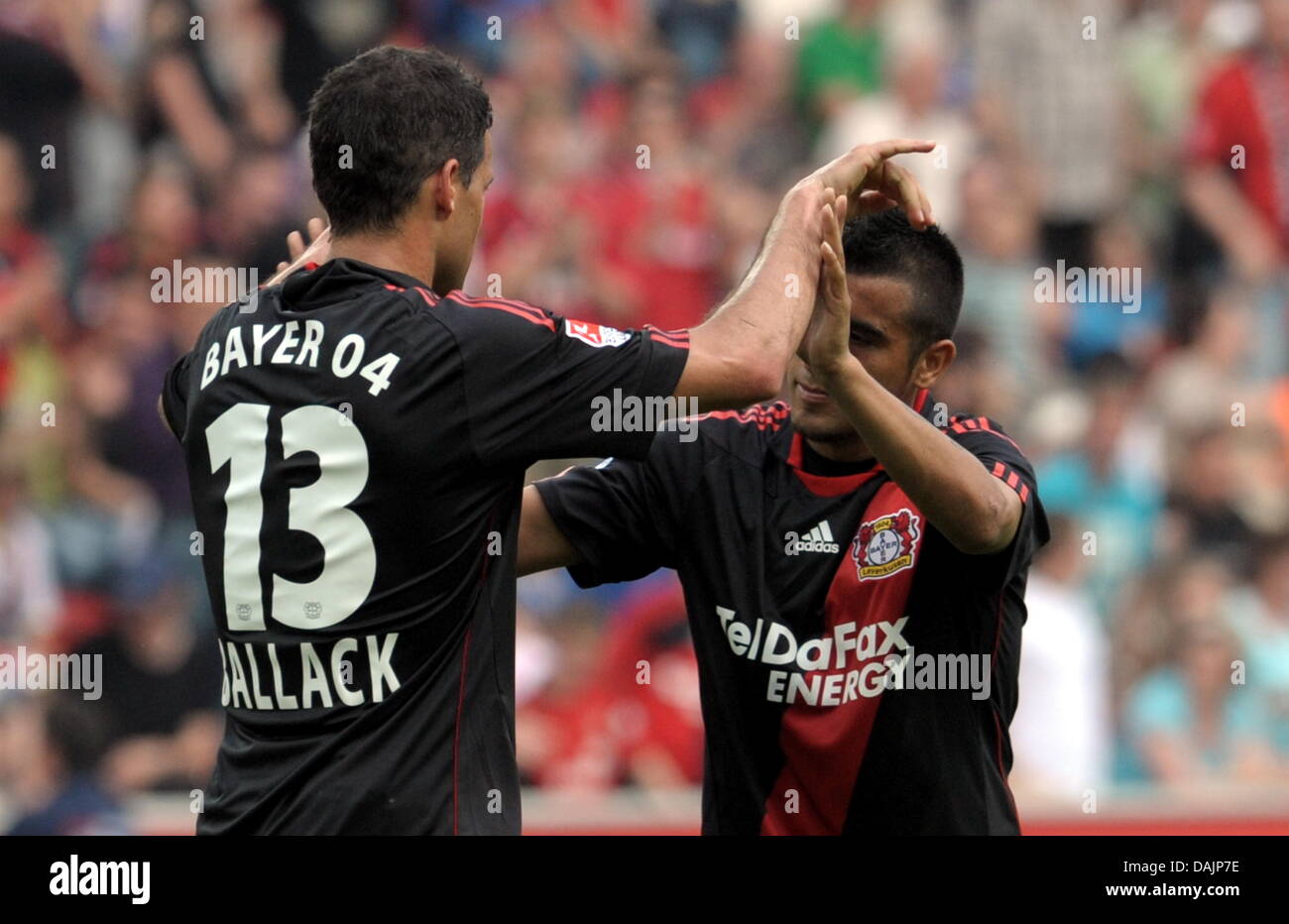 Leverkusen's Michael Ballack (L) and Arturo Vidal celebrate the 2:1 win ...