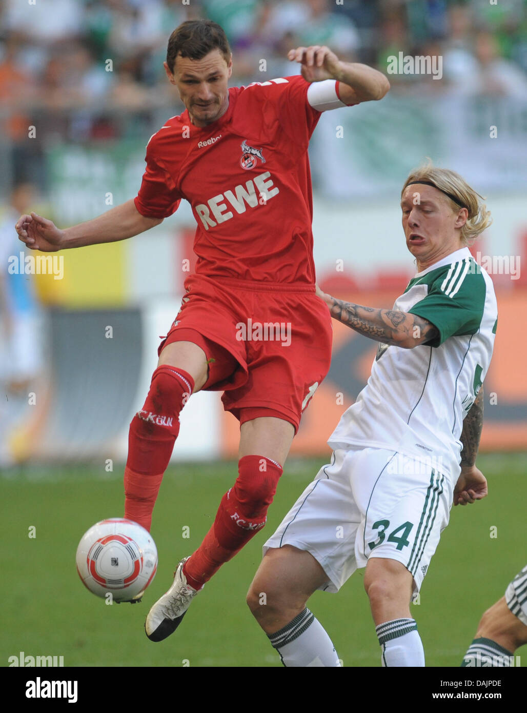 Wolfsburg's Simon Kjaer (R) and Cologne's Milivoje Novakovic vie for ...