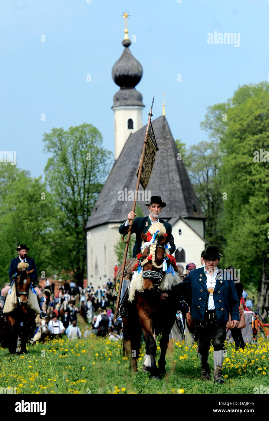 Bavarians in traditional garb ride past the Ettendorf Church during ...