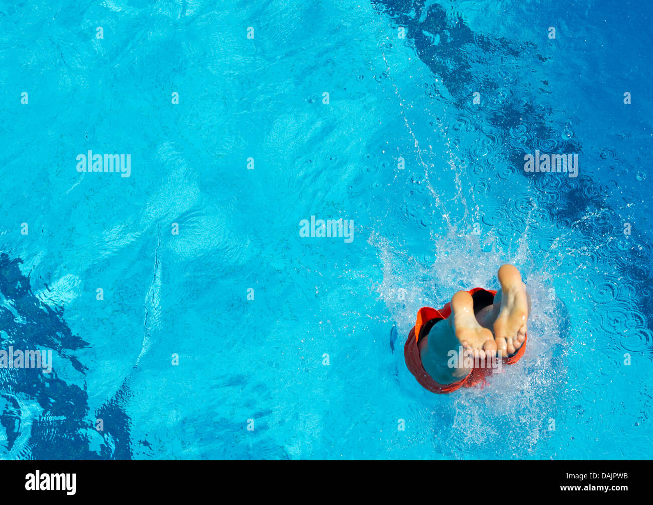 A boy jumps head first into the outdoor pool Moehringen in Stuttgart ...