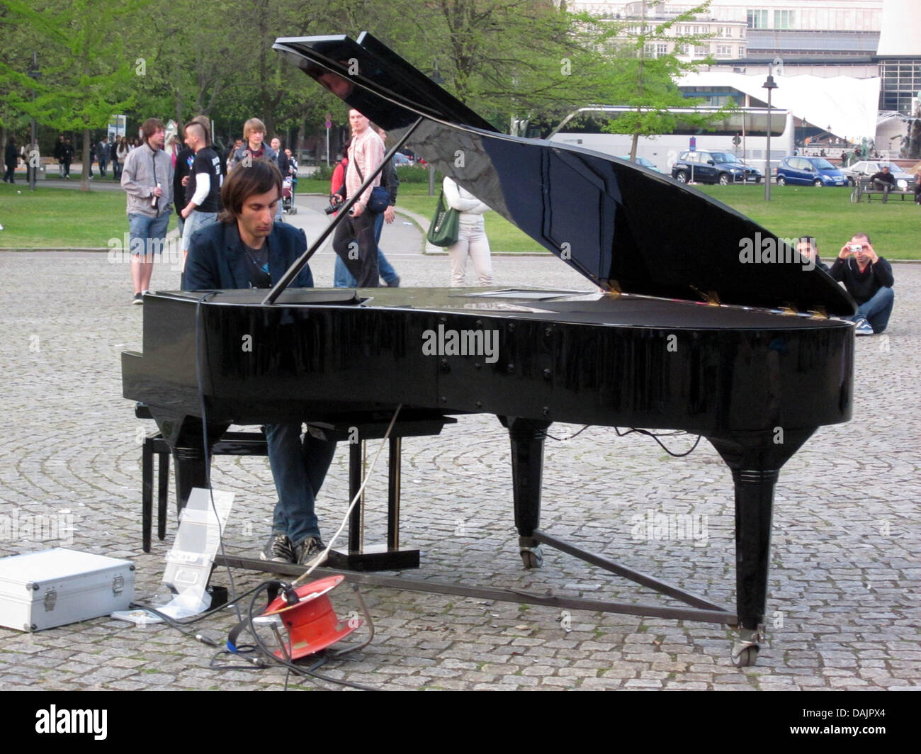 Pianist Davide Martello plays on a grand piano at the Marx Engels Forum ...