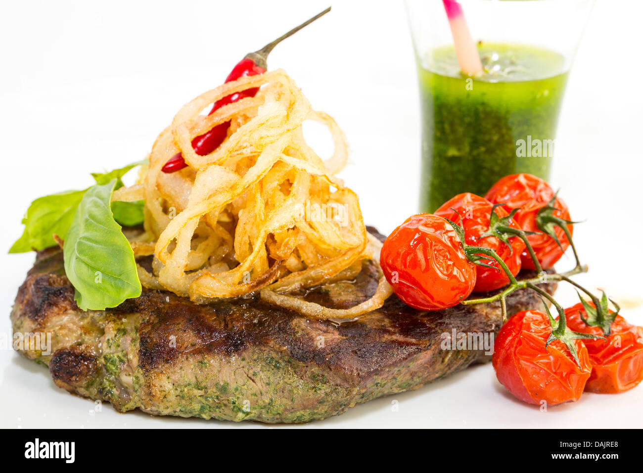 Grilled steak with sauce and greens on white background Stock Photo - Alamy