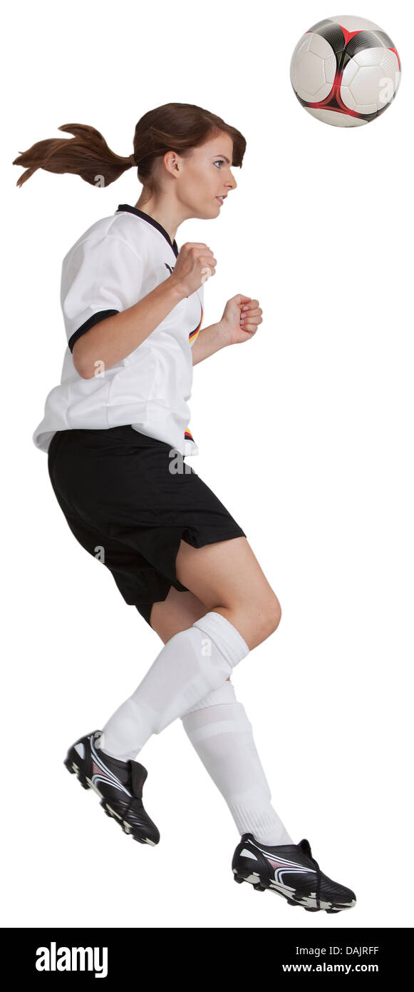 Teenage girl heading football Stock Photo - Alamy