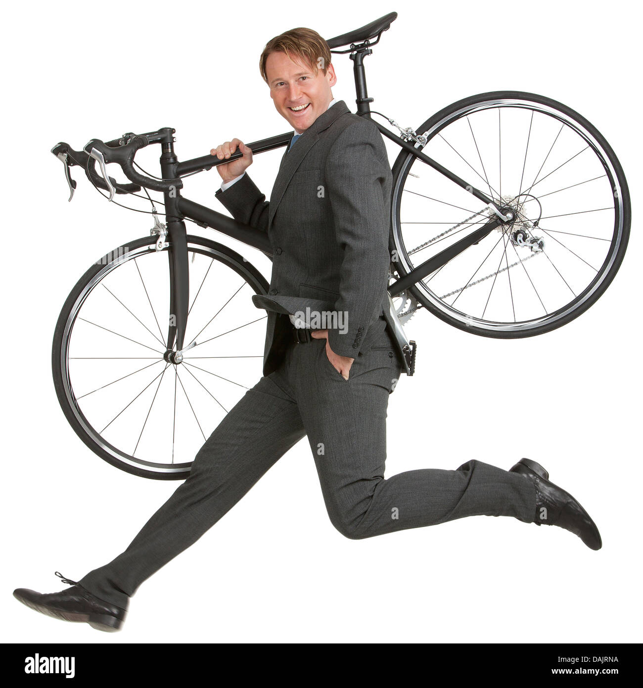 Portrait of businessman carrying bicycle and running, smiling Stock ...