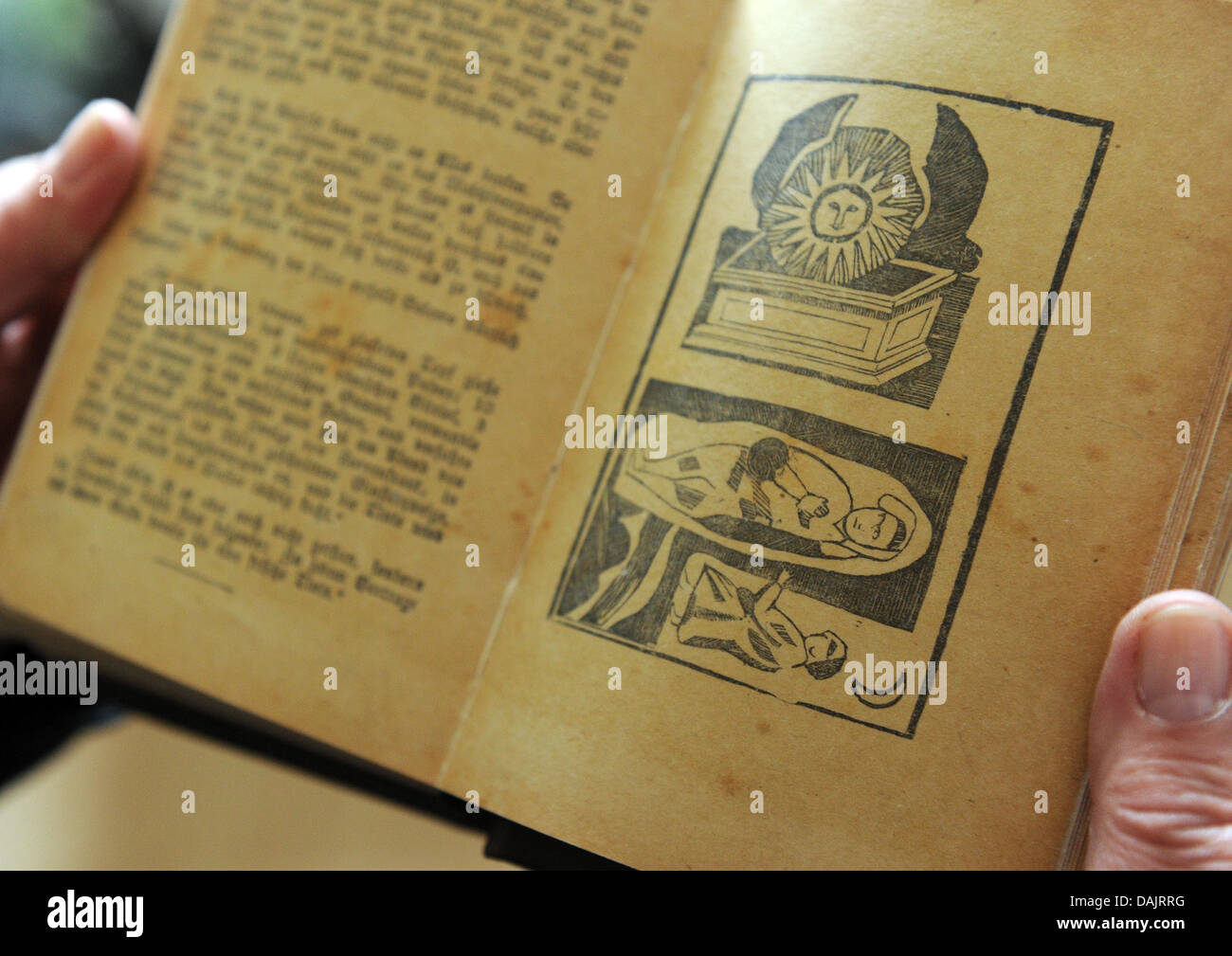 Renate Pahl, also known as witch Pythia, reads a book of spells in ...