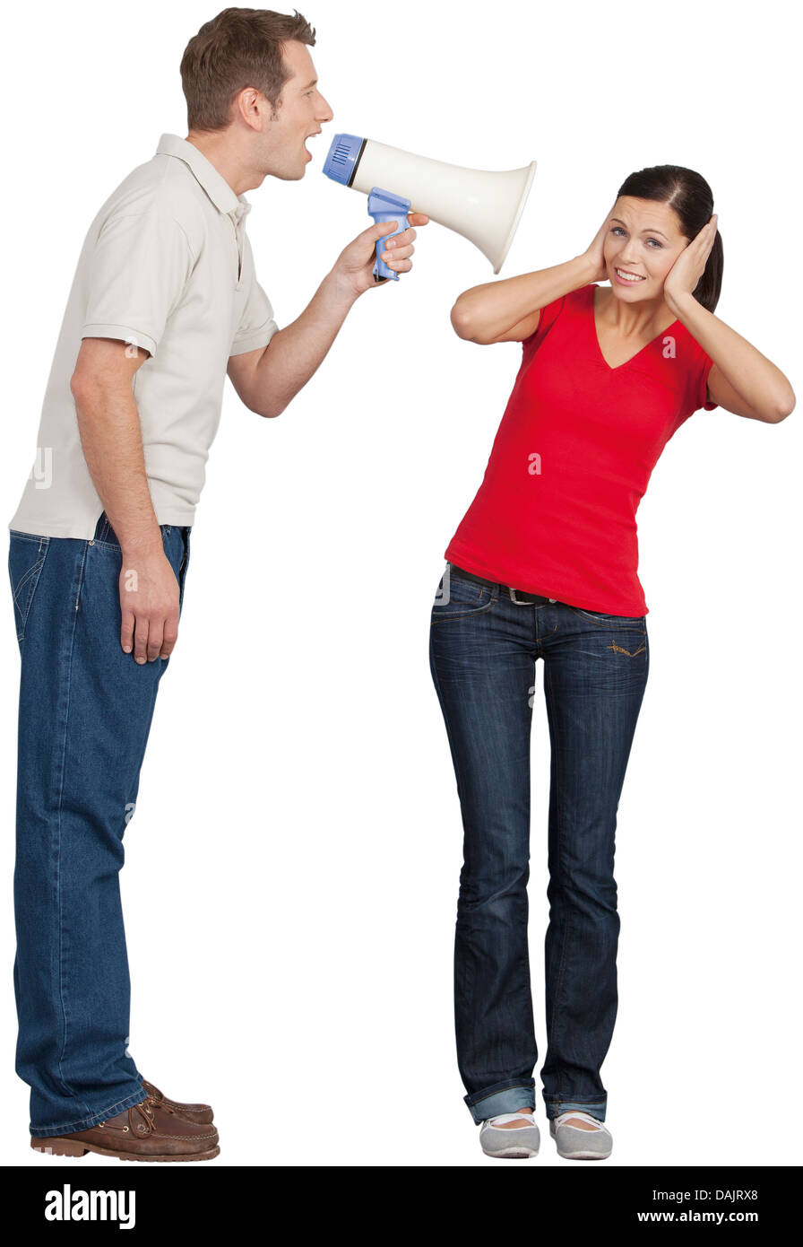 Mid adult man with megaphone shouting on young woman Stock Photo - Alamy