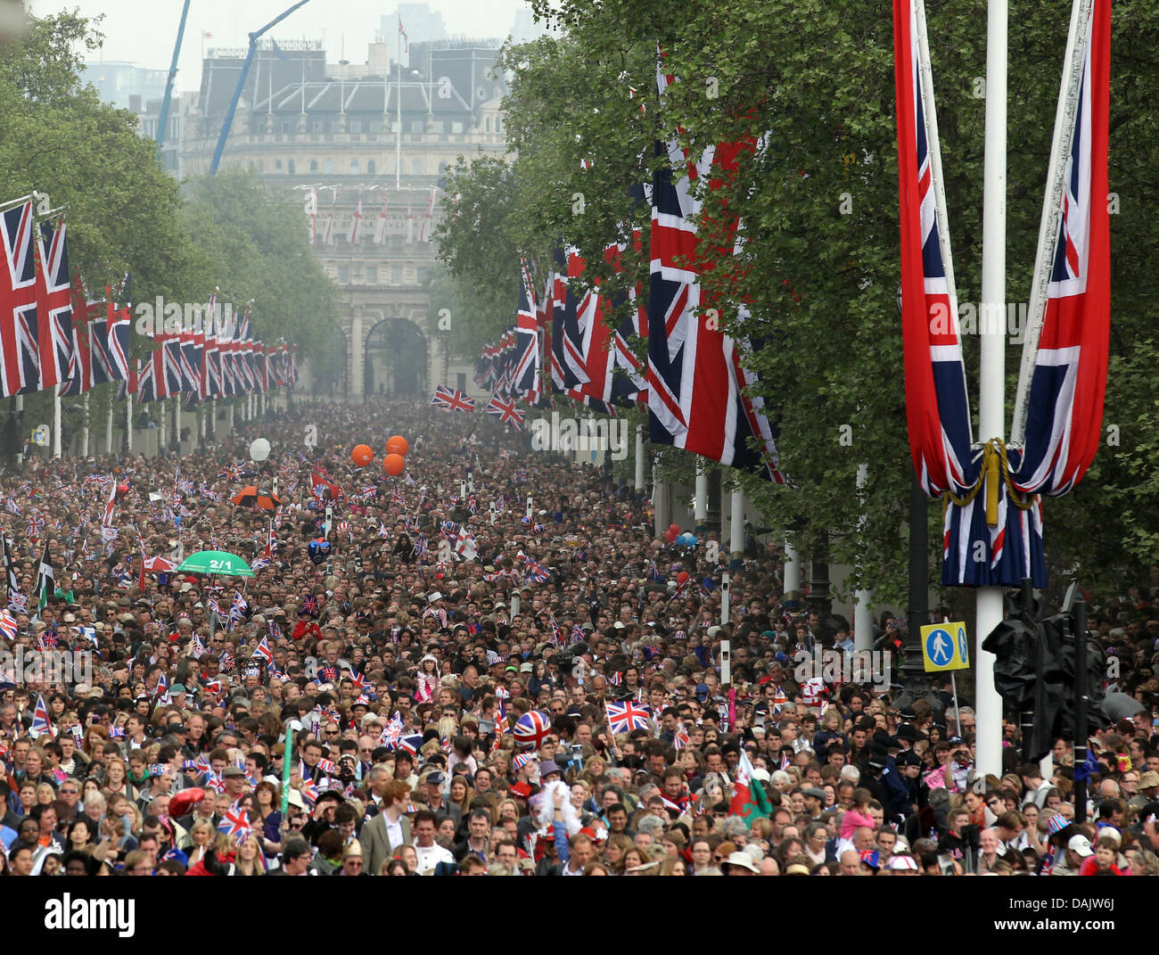 Well-wishers walk along The Mall after the wedding ceremony of Prince ...
