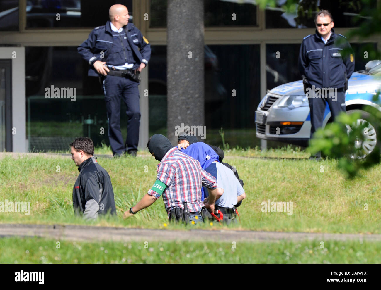One of the three suspected terrorists with a jacket over his head is ...