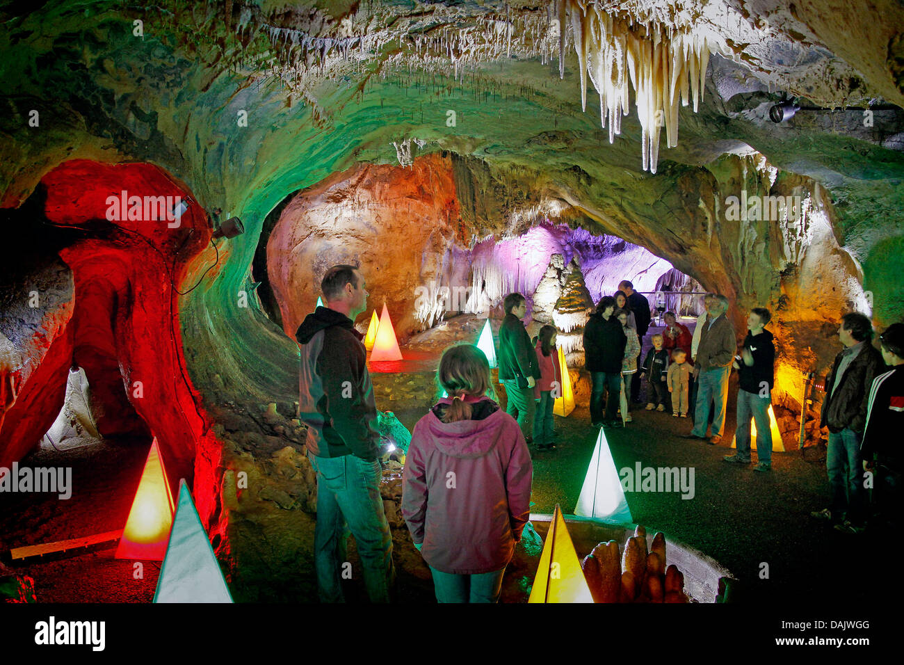 Visitors to Dechen Cave look at the colorful light instalation in the ...