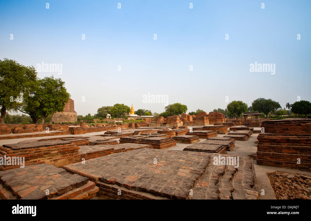 Mini stupas at archaeological site with Dhamek Stupa in the background ...