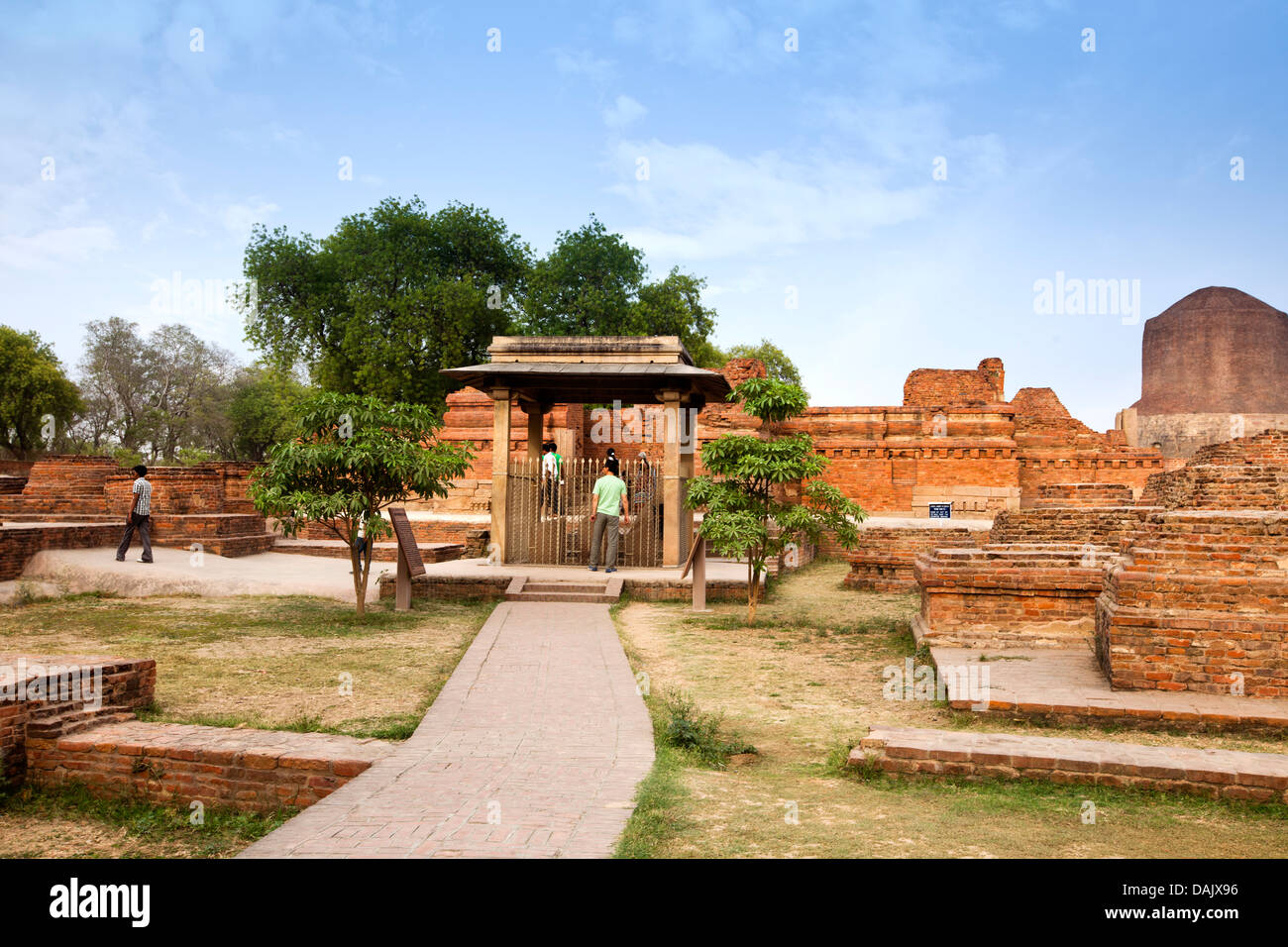 Mini stupas at archaeological site with Dhamek Stupa in the background ...