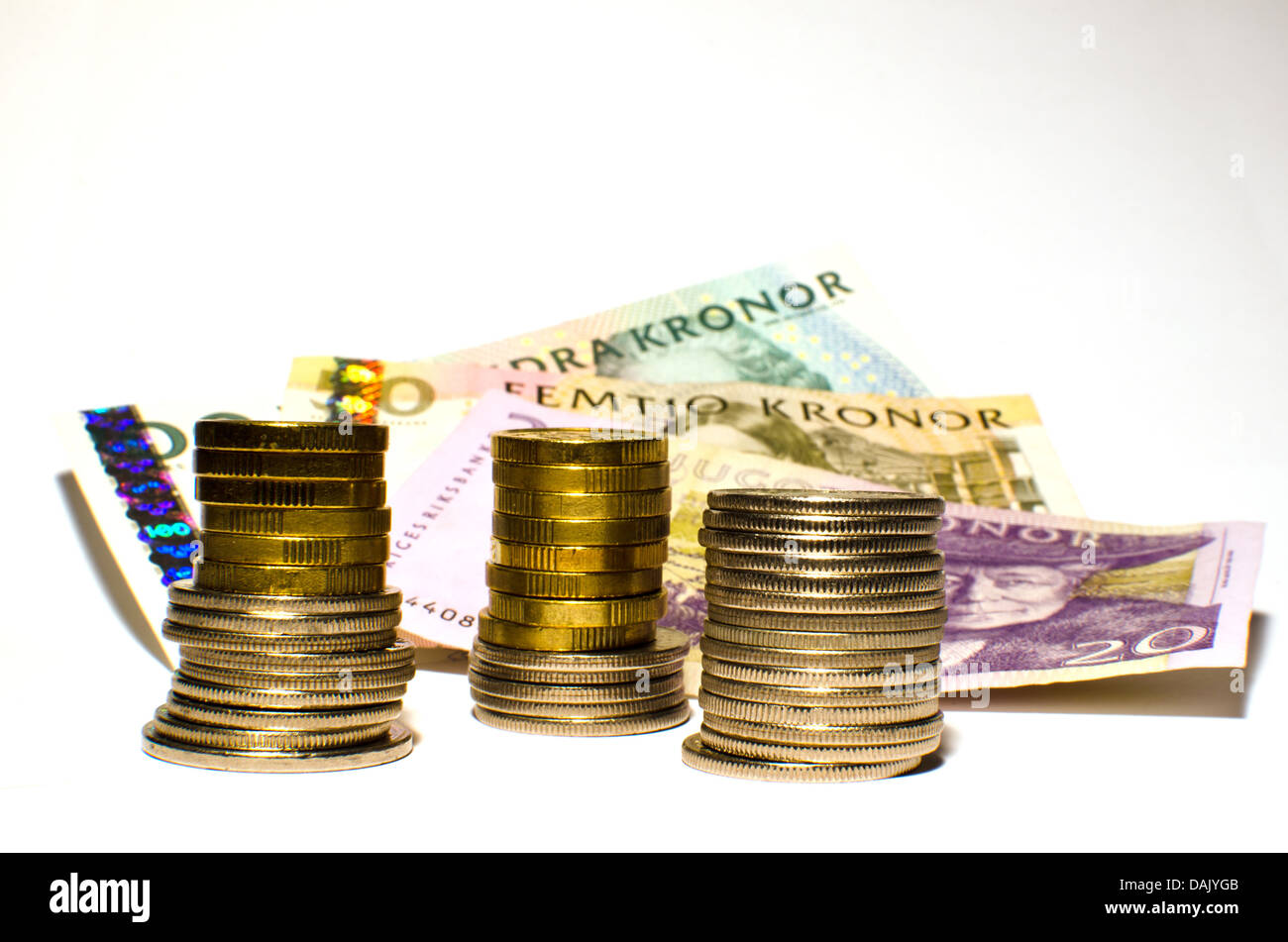 Coinstack in front of papermoney Stock Photo - Alamy