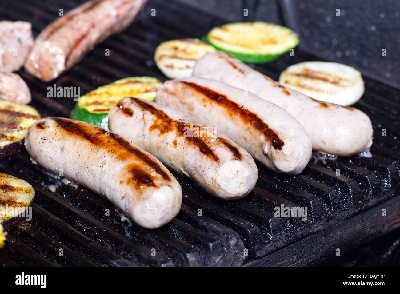 cooking sausages on the grill in the restaurant Stock Photo - Alamy