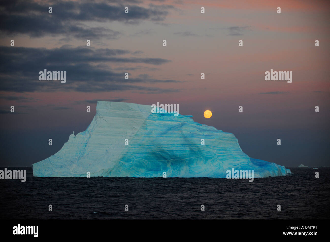 Iceberg in the open sea with the full moon Stock Photo - Alamy