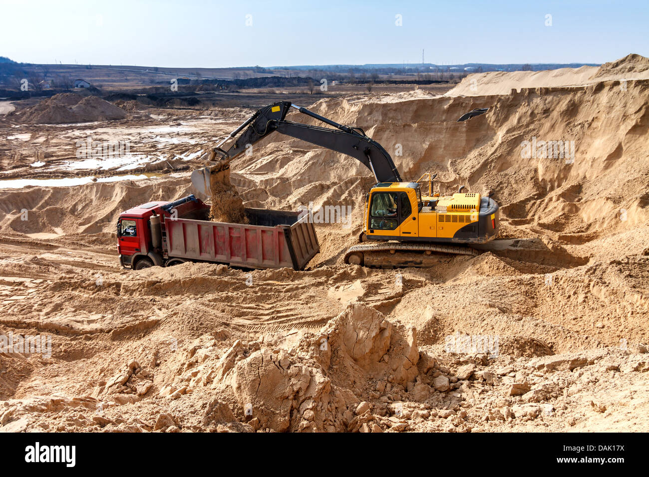 Excavator Loading Dumper Truck at Construction Site Stock Photo - Alamy