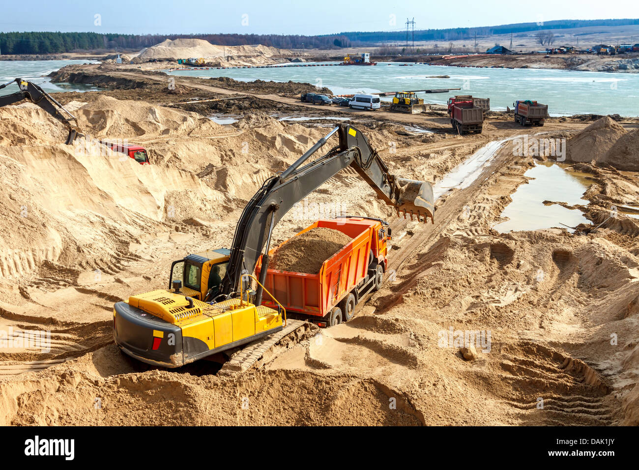 Excavator Loading Dumper Truck at Construction Site Stock Photo - Alamy
