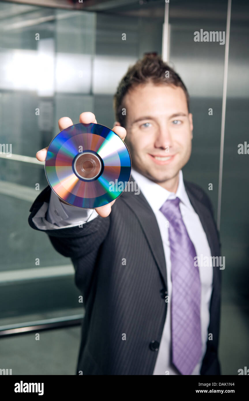 Businessman holding disc Stock Photo - Alamy