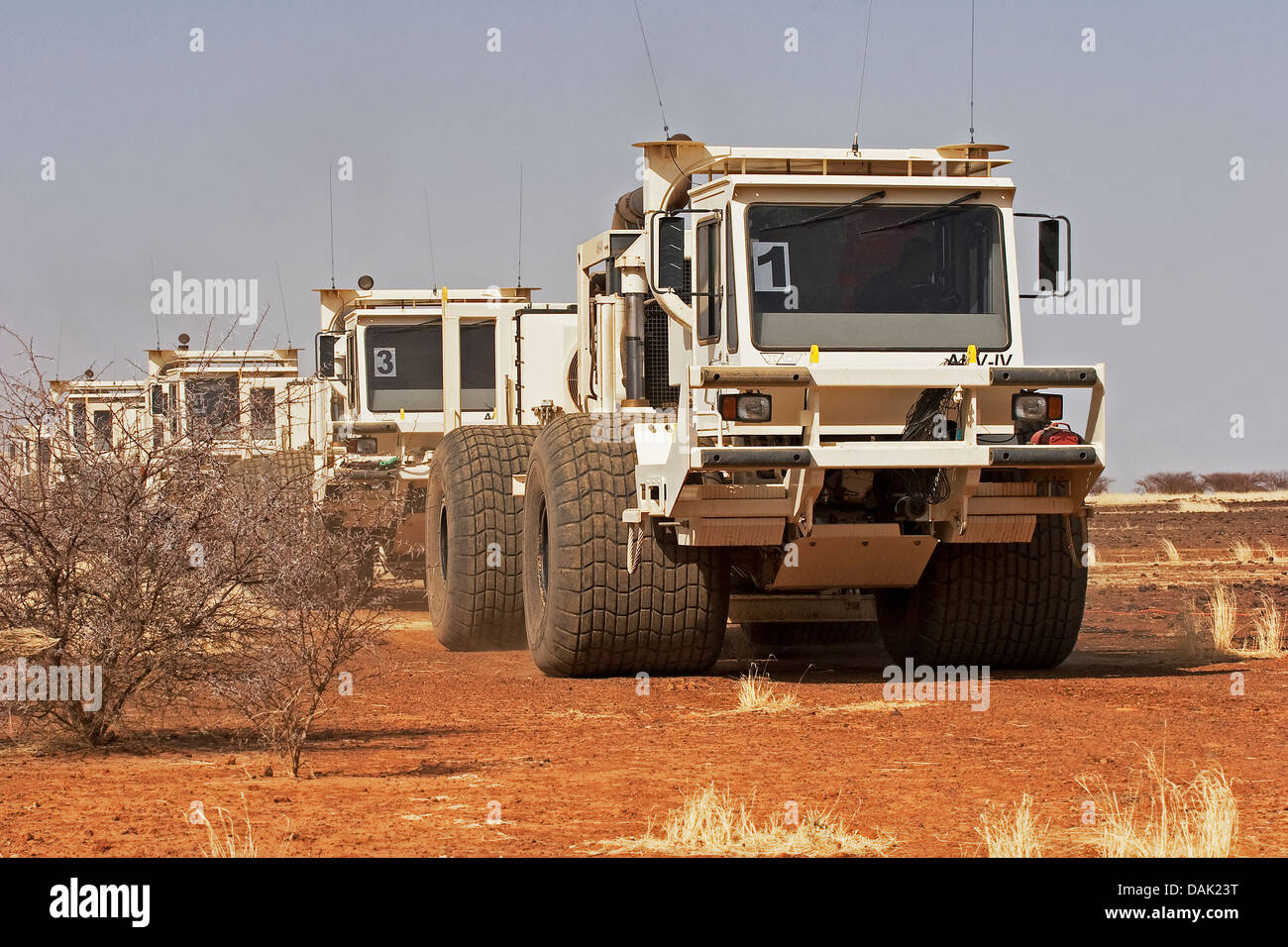 Oil exploration Mali. Seismic vibrator vehicles moving across desert ...