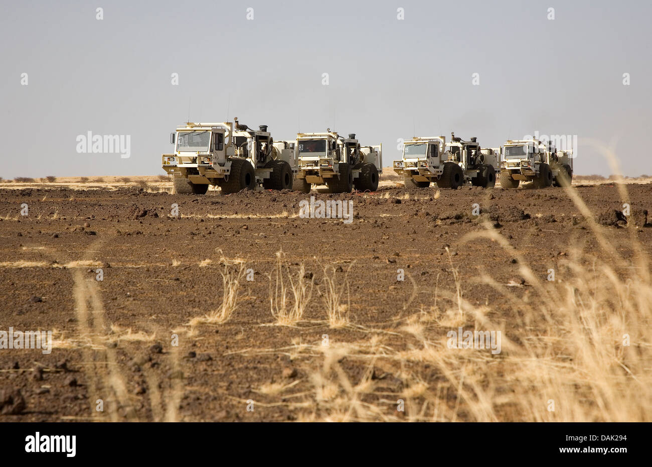 Oil exploration Mali. Seismic vibrator vehicles moving across desert ...