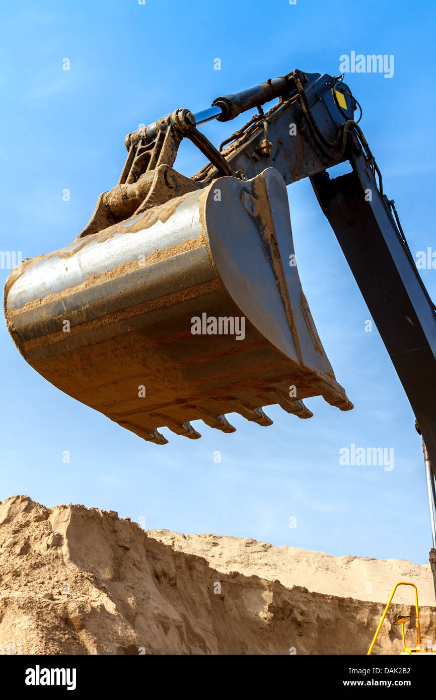 Excavator Bucket across the Blue Sky Stock Photo - Alamy
