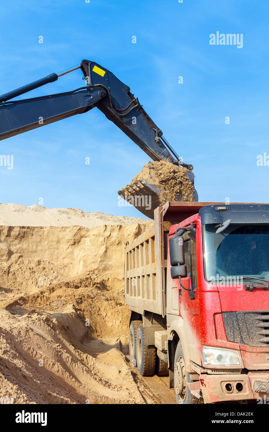 Excavator Loading Dumper Truck at Construction Site Stock Photo - Alamy