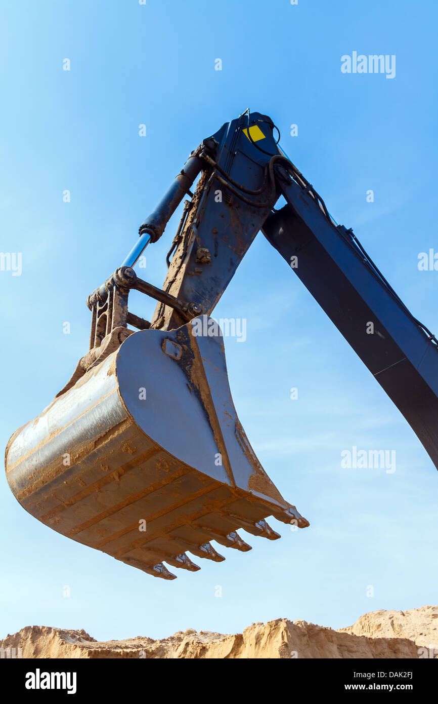 Excavator Bucket across the Blue Sky Stock Photo - Alamy