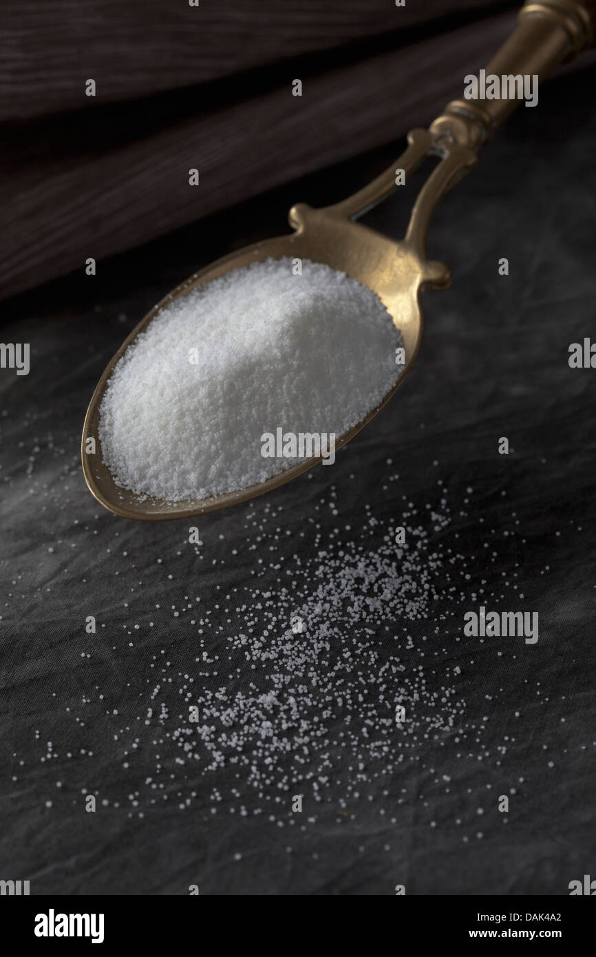 Salt on brass spoon, close up Stock Photo - Alamy