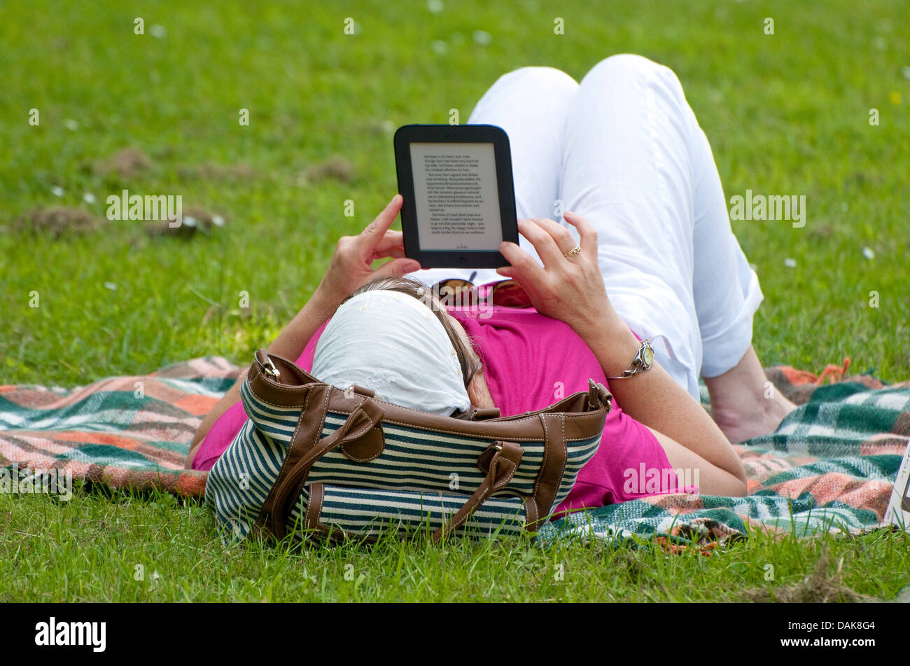 Person tablet grass hi-res stock photography and images - Alamy