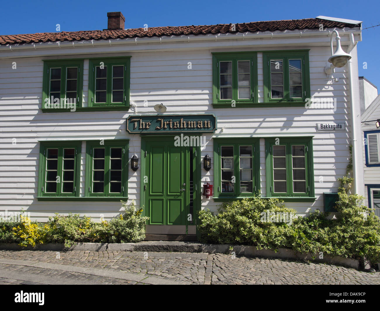 Narrow cobbled street in Stavanger Norway, traditional wooden paneled ...