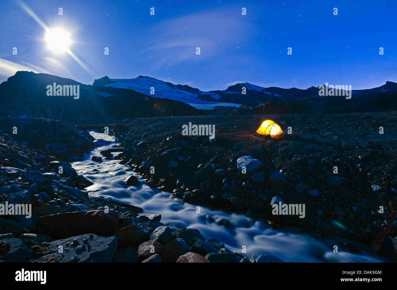 camping near a river lit by moonlight, Zermatt, Swiss Alps, Switzerland ...
