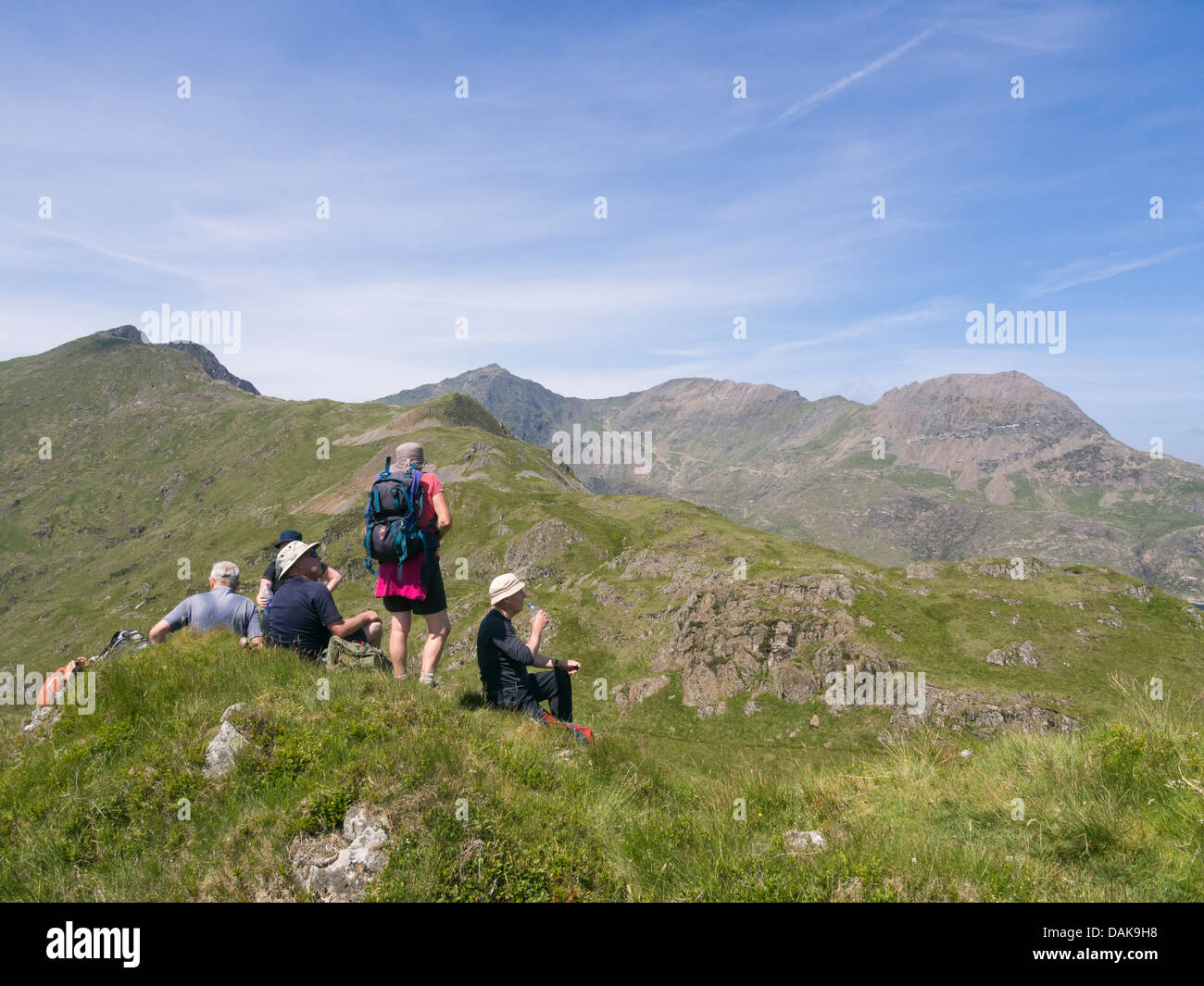 Ramblers resting on Gallt y Wenallt on Snowdon horseshoe with view to ...