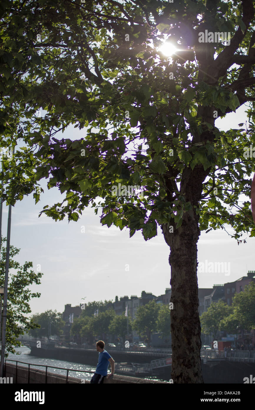 Man standing beside a railing Stock Photo - Alamy